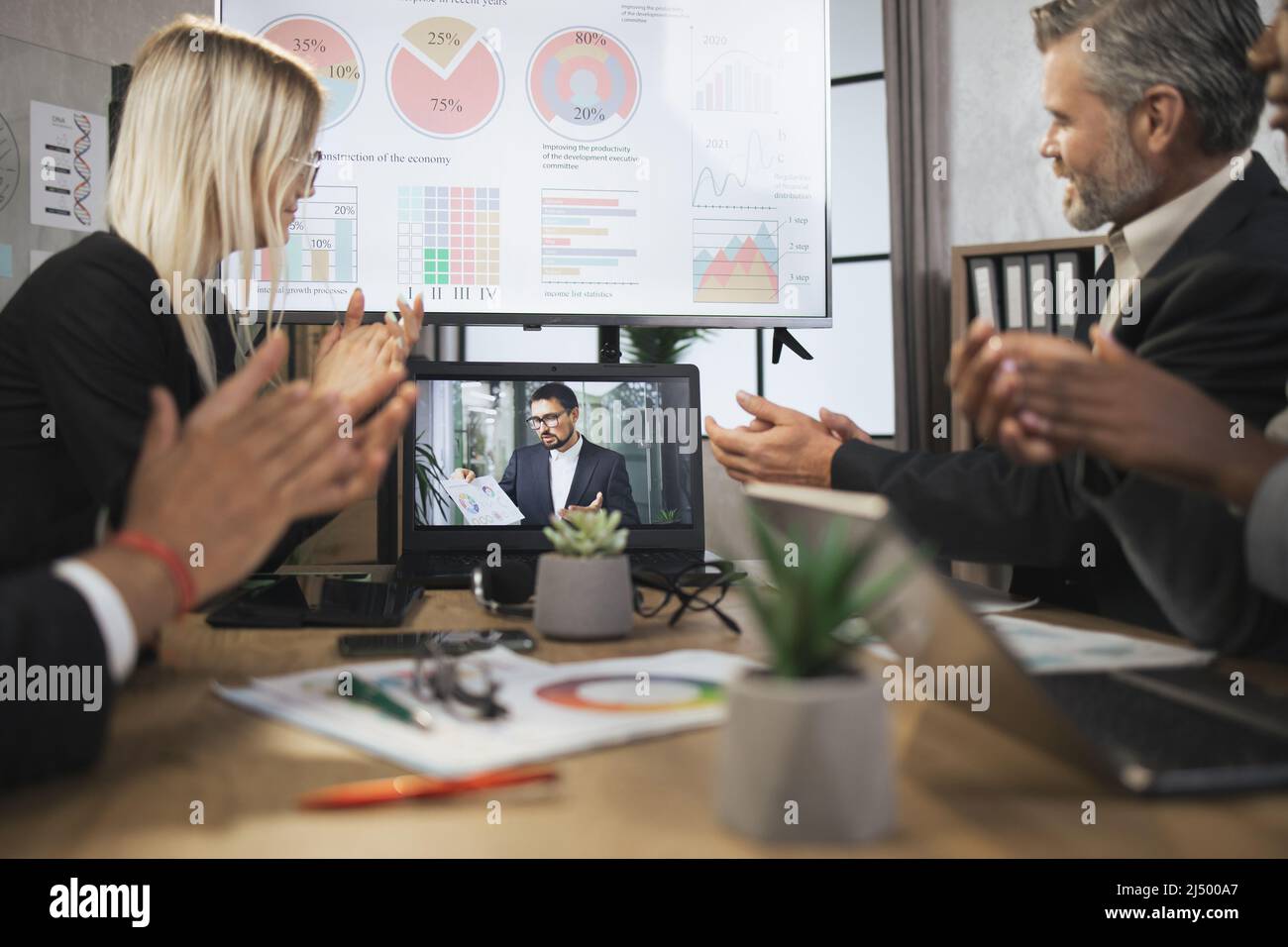 Group of four skillful multiethnical businesspeople clapping hands and ...