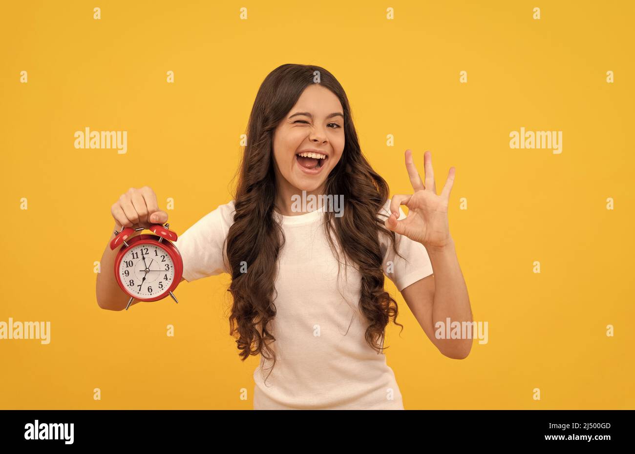happy kid hold retro alarm clock showing time, ok Stock Photo - Alamy
