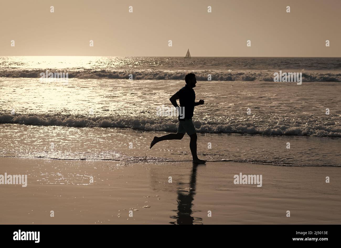 athletic man runner silhouette run on summer beach with sea water and ...