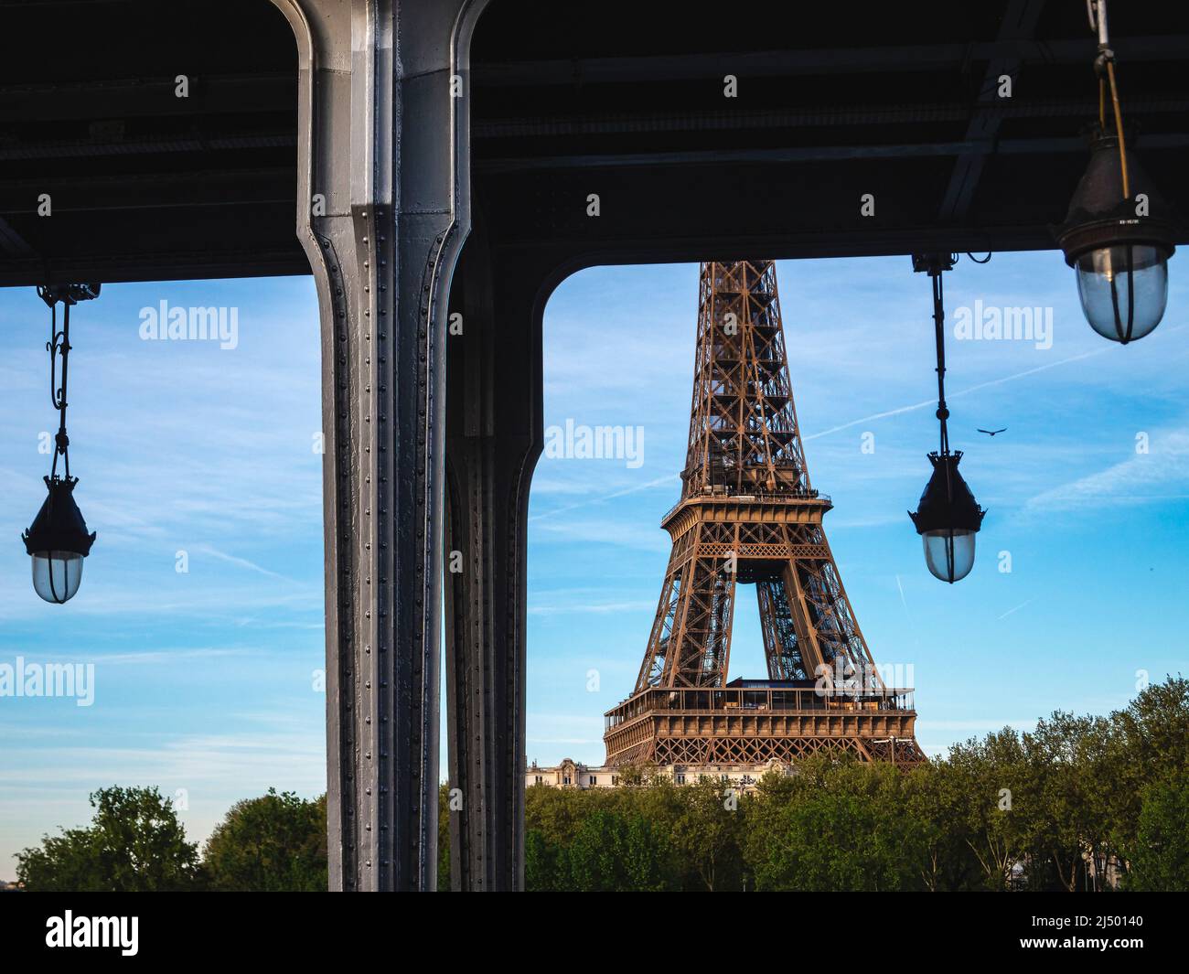 Daytime view of the Eiffel Tower between one of the Seine river bridges ...
