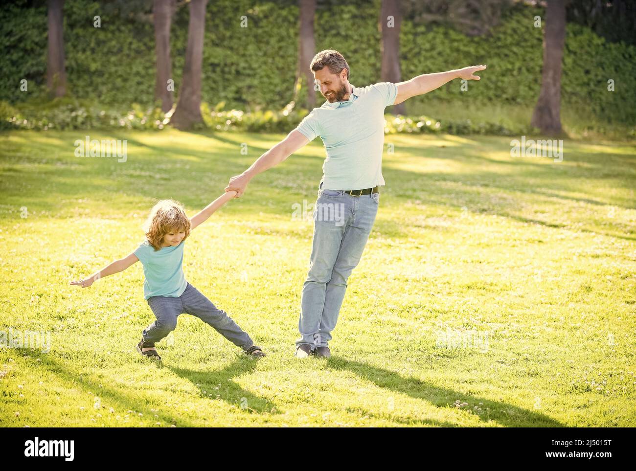 Happy boy child pull fathers hand playing on summer outdoors, fun Stock ...
