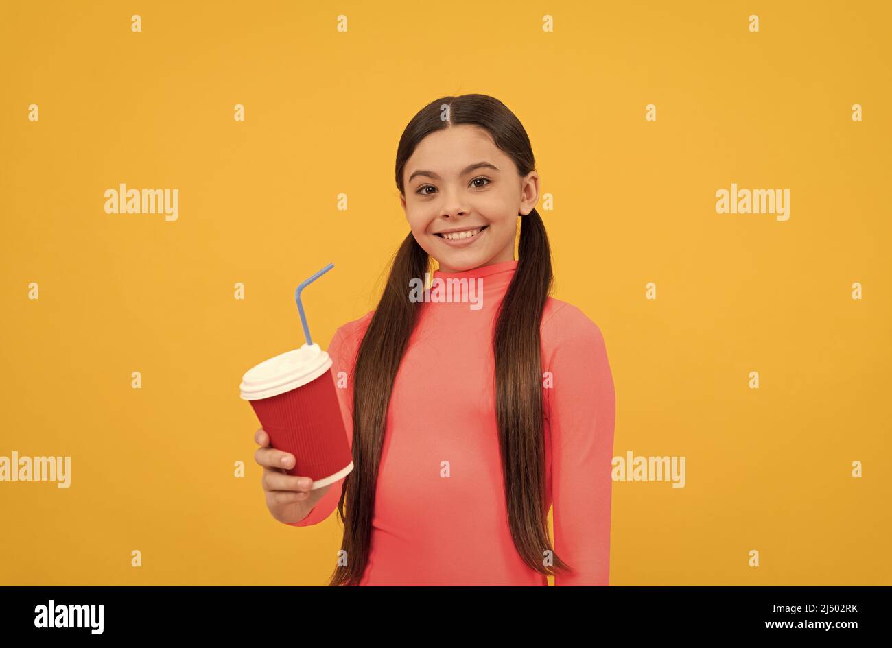 cute portrait of enjoyment. happy child hold plastic cup with cocoa ...