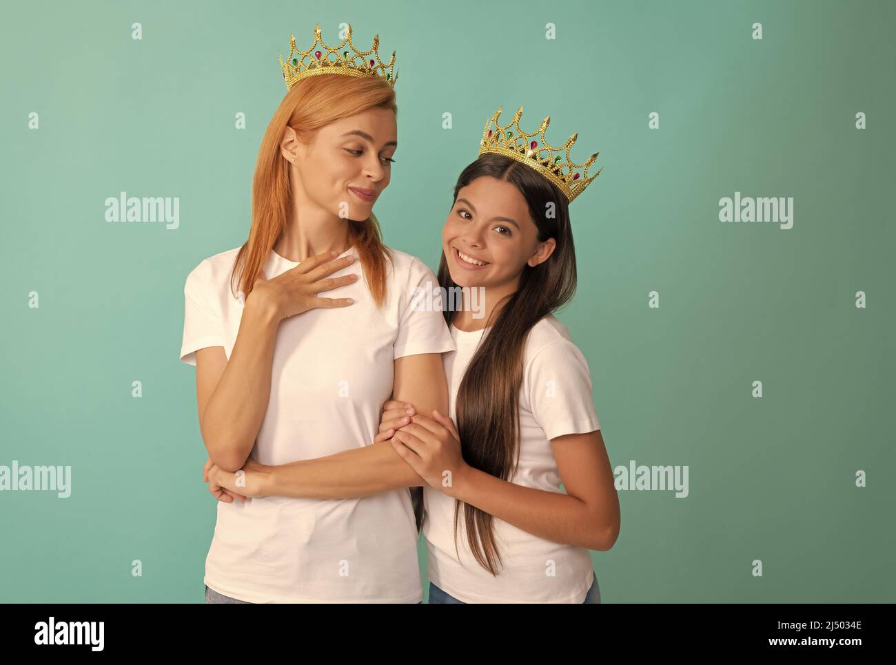 Selfish woman mother smile at happy girl child in crowns blue ...