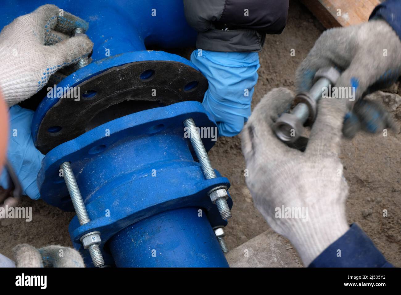 Workers installing water supply pipeline system, close up Stock Photo ...