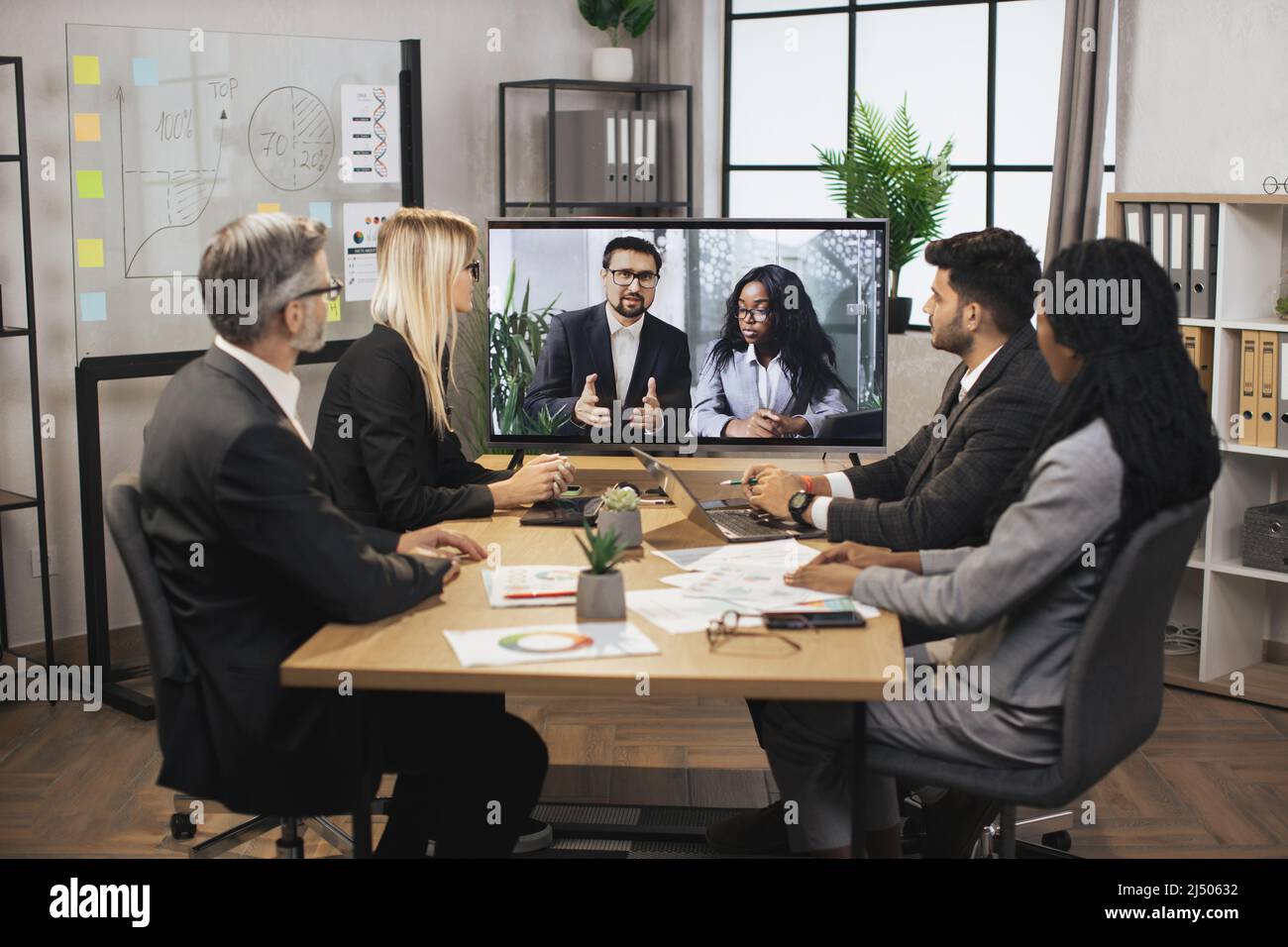 Confident Caucasian business man and African woman tells business ...