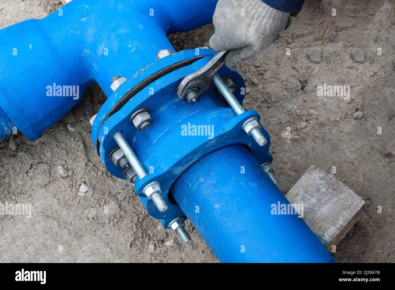 Workers installing water supply pipeline system, close up Stock Photo ...