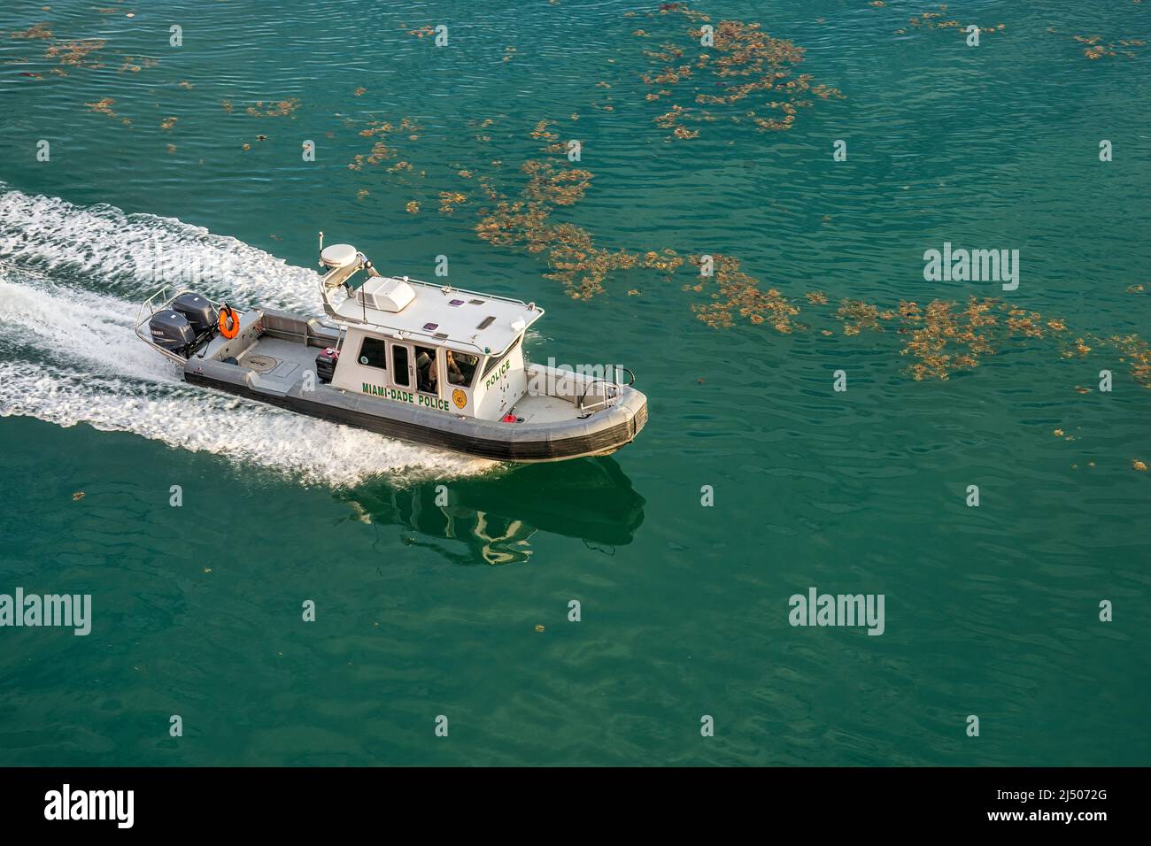 A Miami-Dade County Police Boat patrols the water around the Port of ...