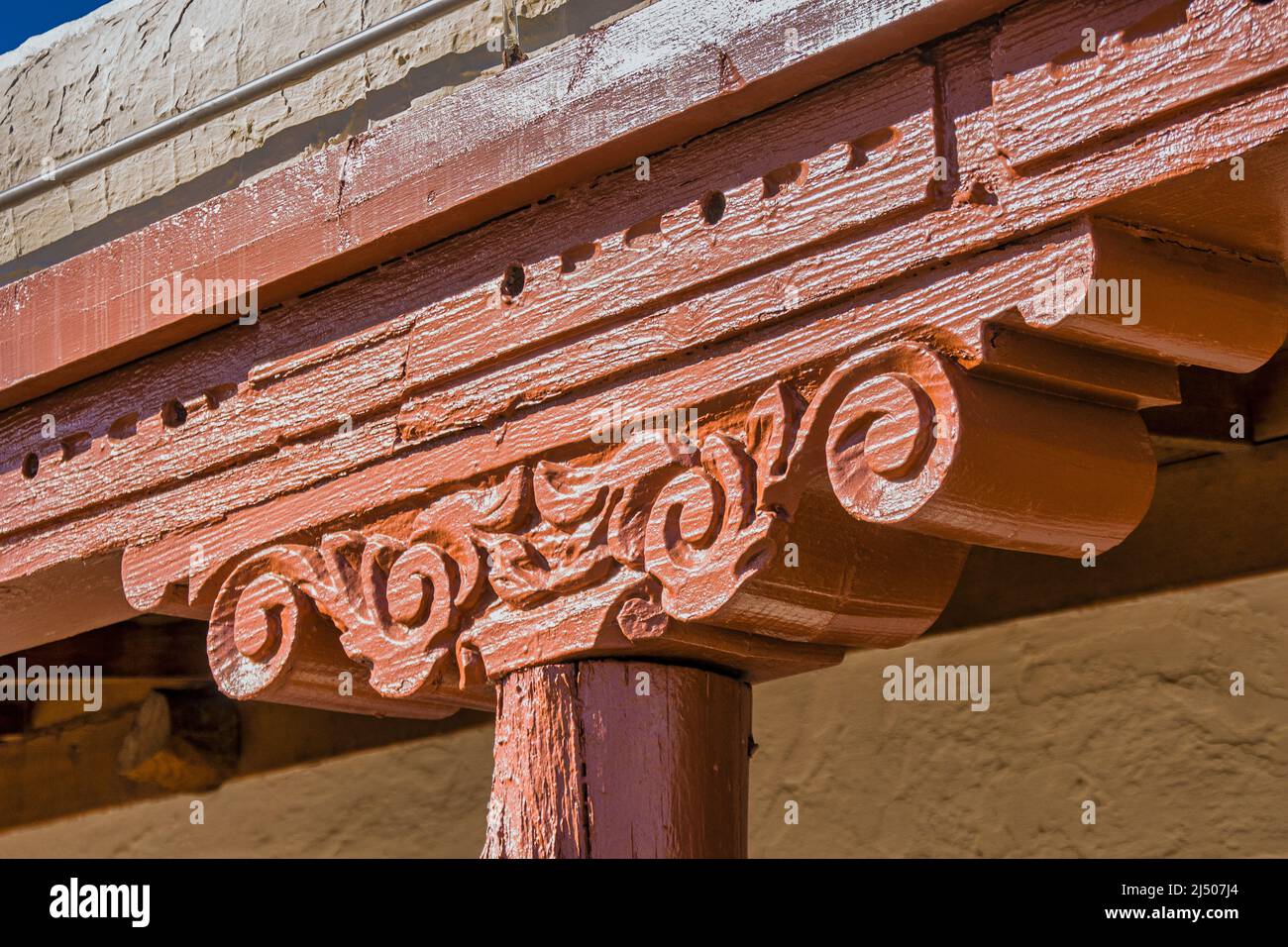 Elaborately carved wooden column at a vintage Southwestern style motel ...