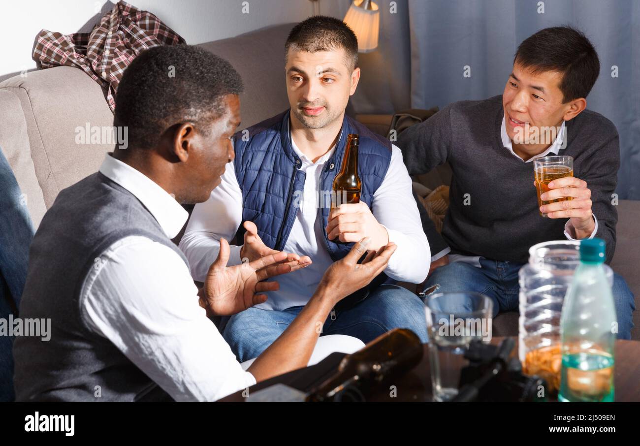 Three men are drinking beer and talking about life in time rest ...