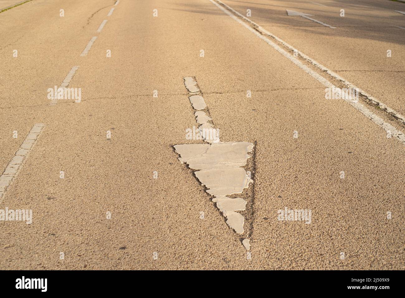 Pavement signs in the sunset Stock Photo - Alamy