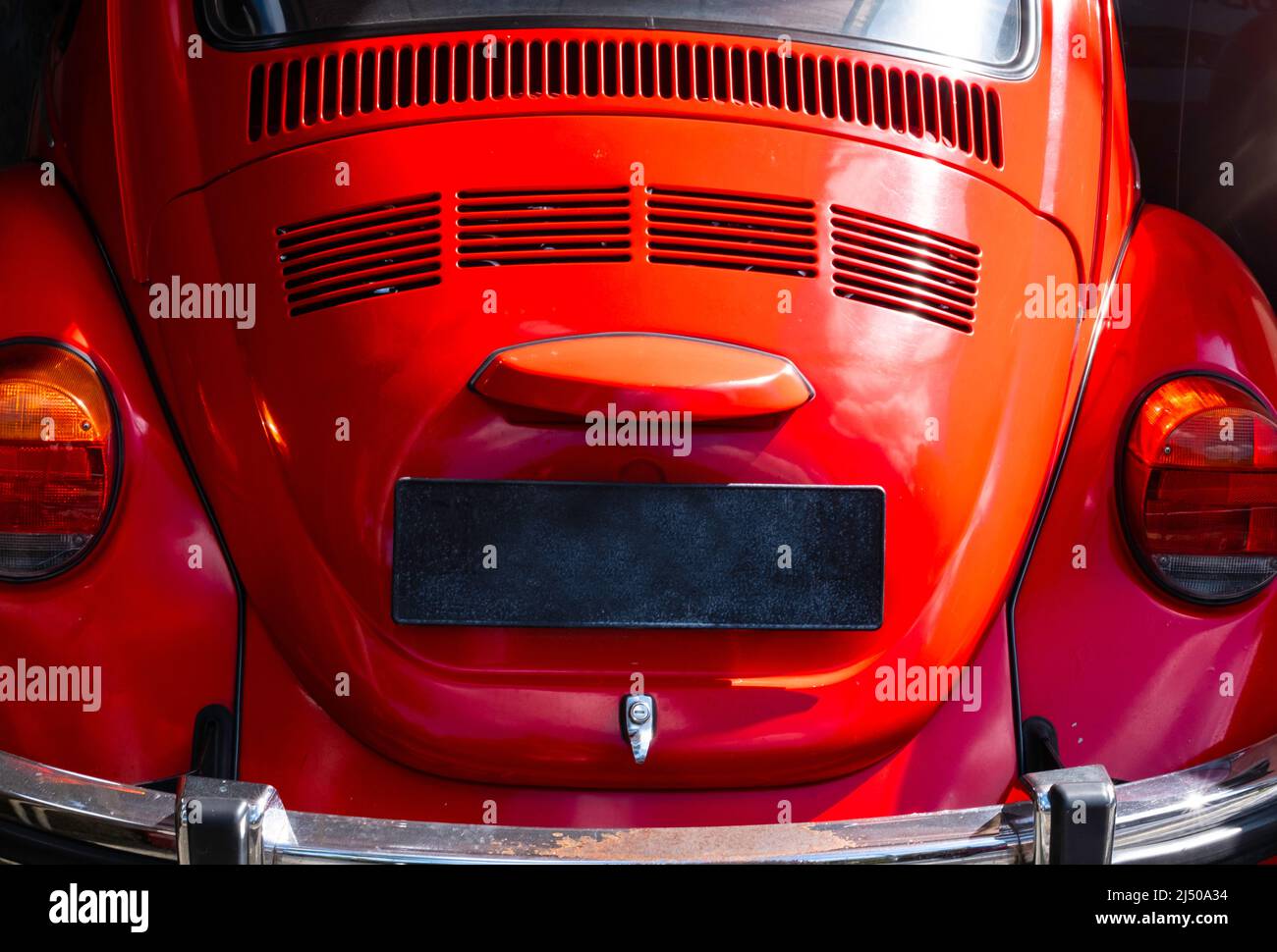 Back of red automobile with blank license plate for mock up and copy ...