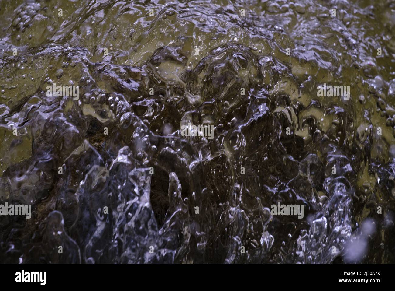 Texture of water in a natural state, in a river when splashing against ...