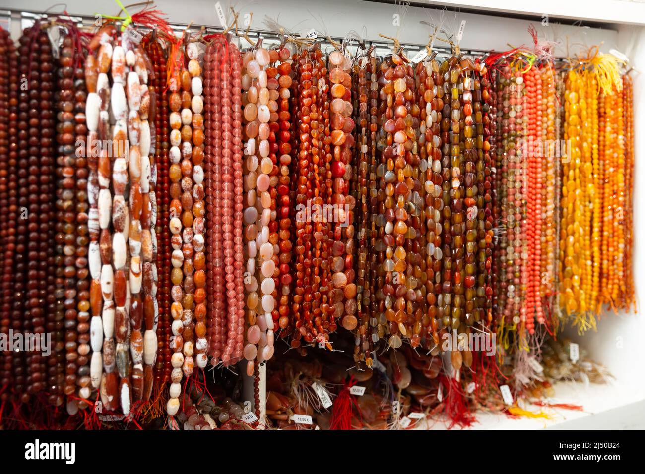 Beads from gems strung on thread in jewelry accessories store Stock ...