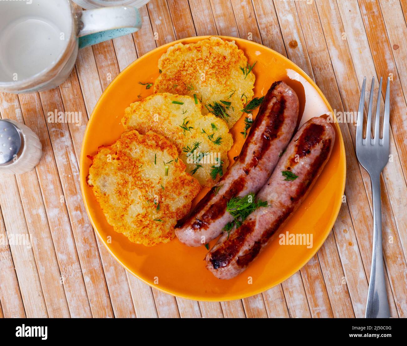 National dish of Belarusian cuisine is draniki with fried sausages ...
