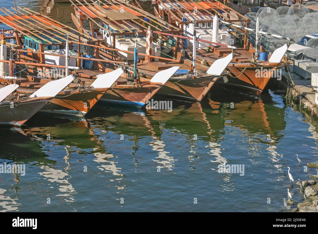 Traditional fishing dhows lined up near Sharjah Bridge in Sharjah in ...