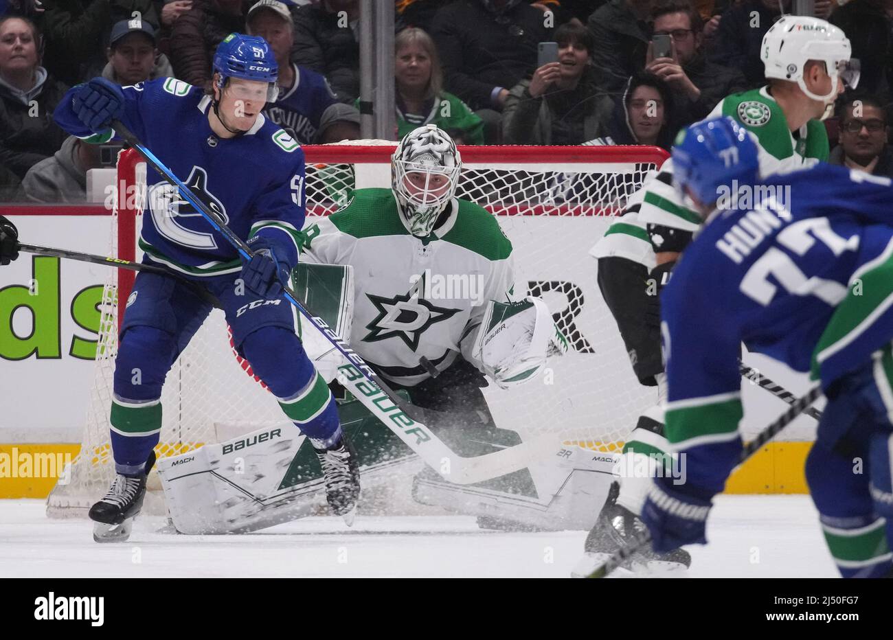 Dallas Stars goalie Jake Oettinger, second right, makes the save as ...