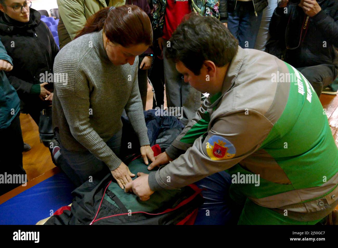 An instructor shows cardiopulmonary resuscitation (CPR) actions during ...