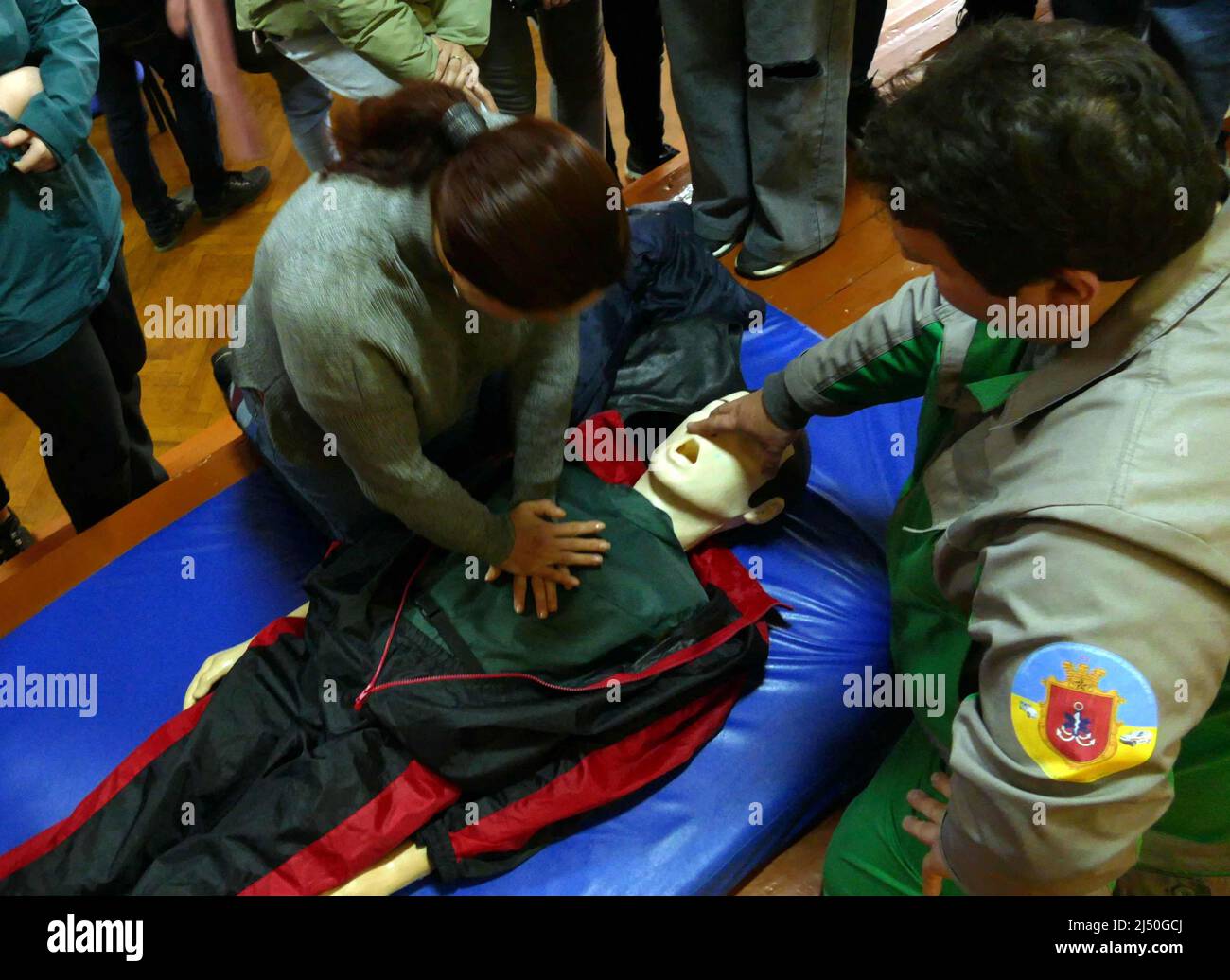 An instructor shows cardiopulmonary resuscitation (CPR) actions during ...