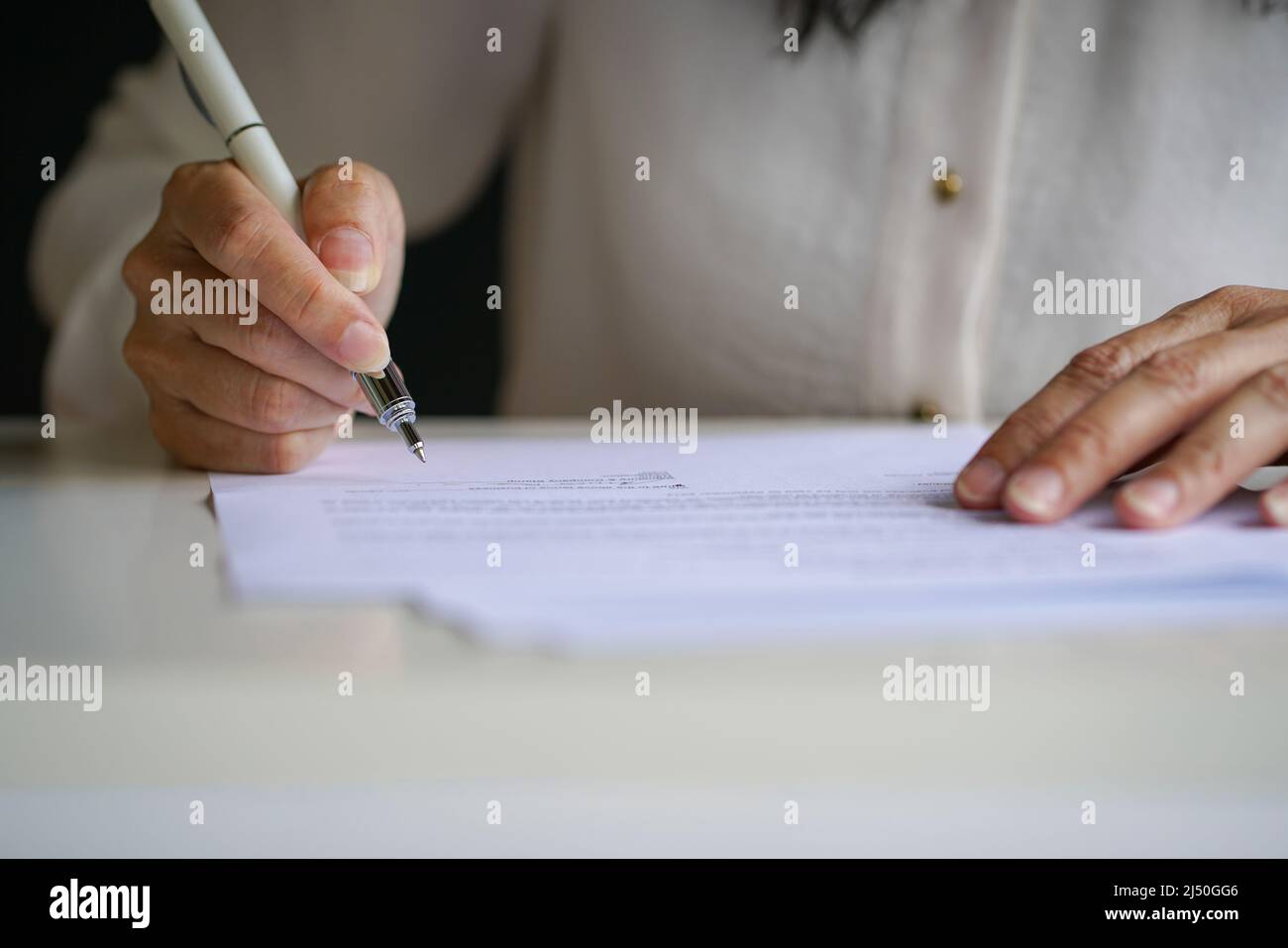 Hand of businesswoman sign on paper document. Close up view, copy space ...