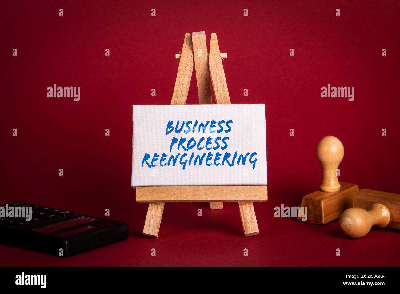 Business Process Reengineering. Miniature easel with office supplies on ...