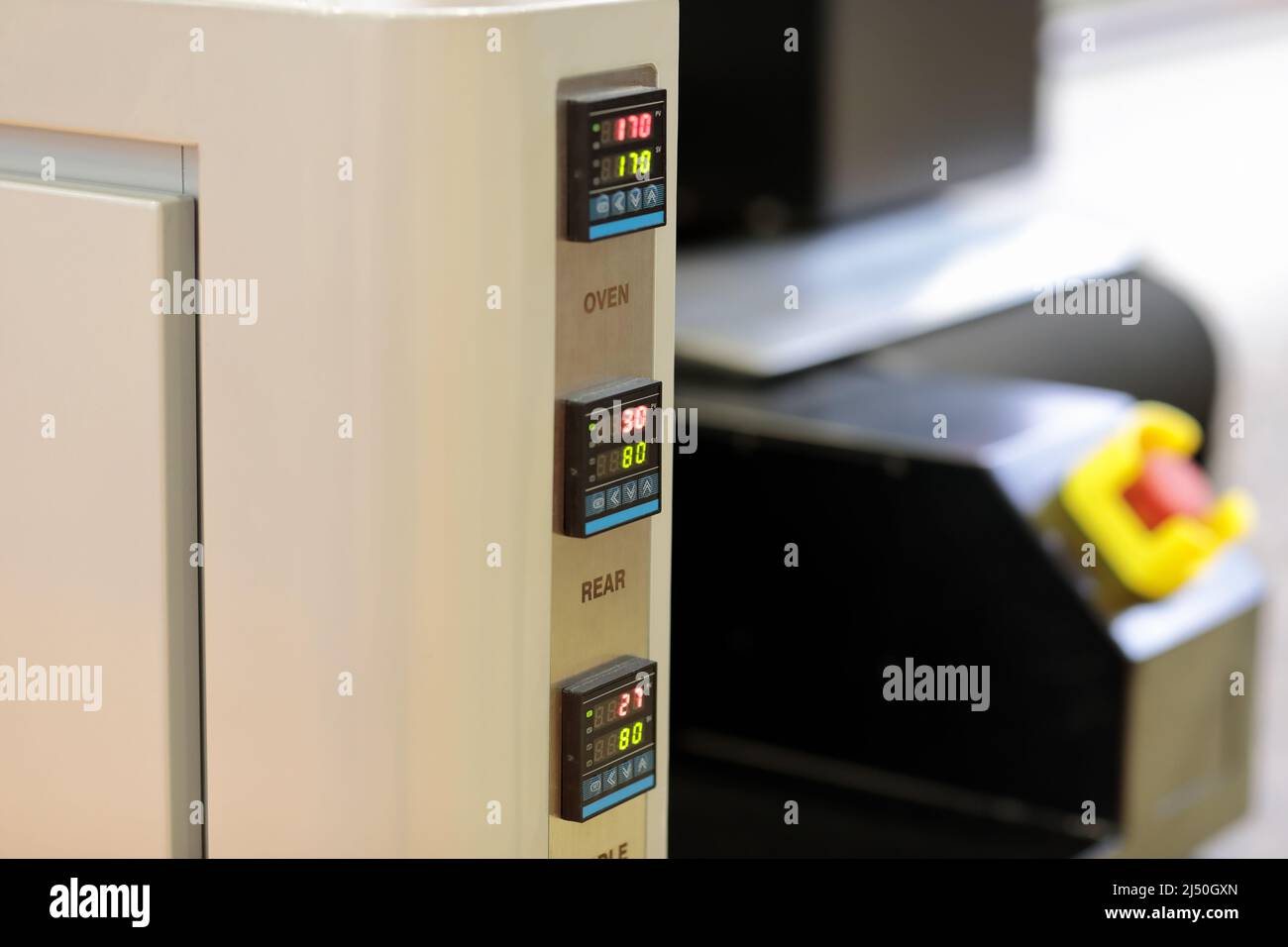 Digital temperature controllers on a control panel of industrial ...