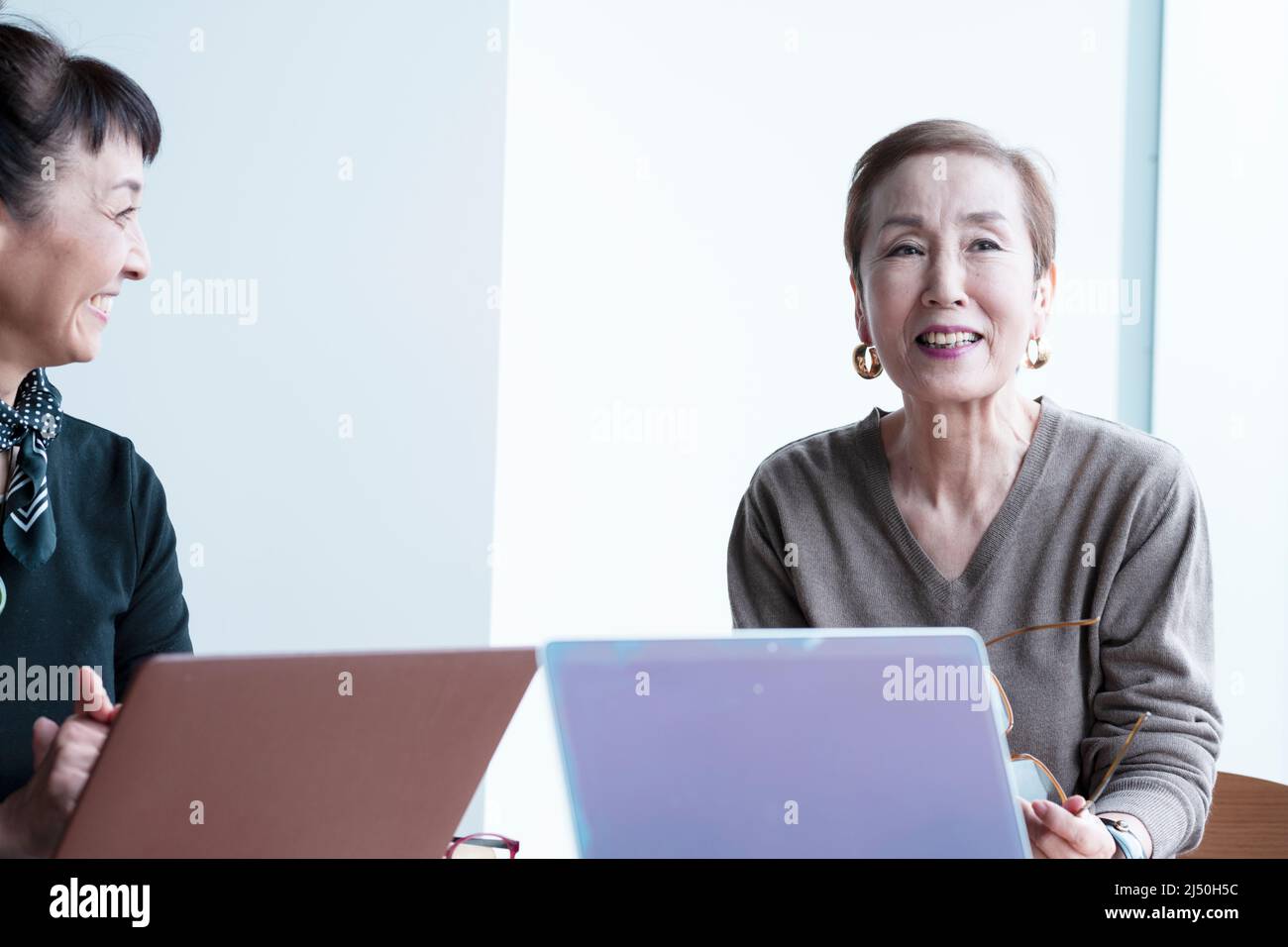 Female Administrators Having a Meeting Stock Photo - Alamy