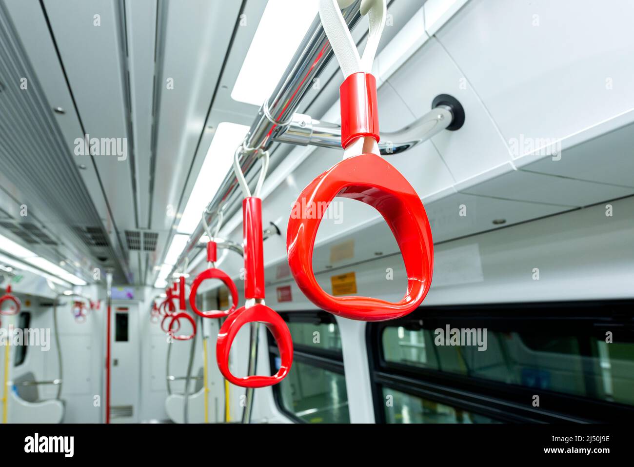 Empty handrails for passenger safety inside the train Stock Photo - Alamy