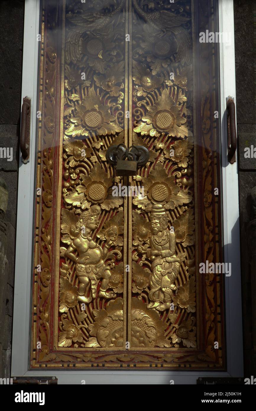 A door that is decorated with hand-made carvings at Tuluk Piyu Batur ...