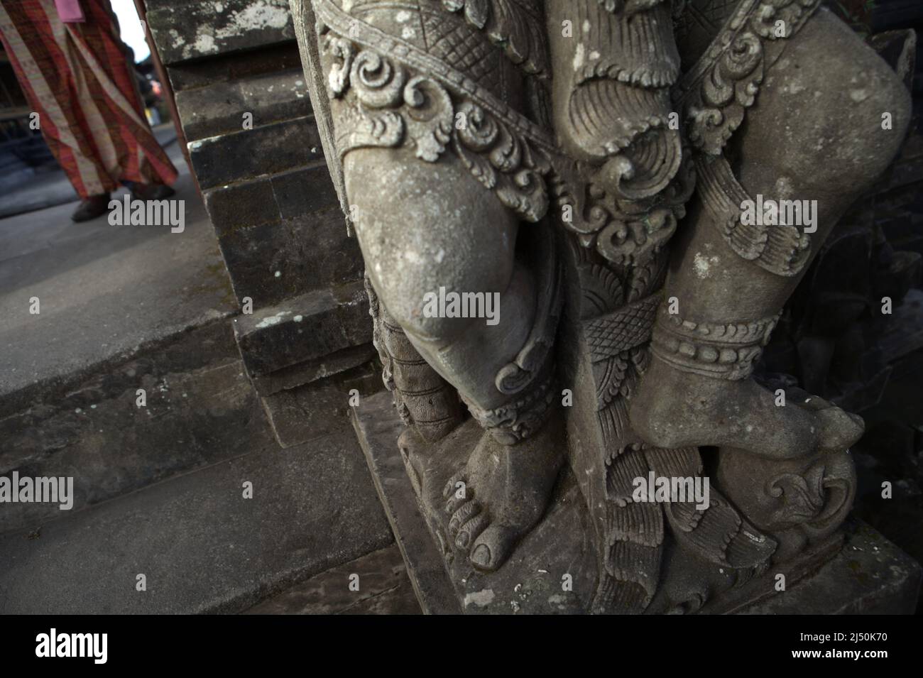 The feet of a dvarapala guardian statue at Tuluk Piyu Batur temple in ...