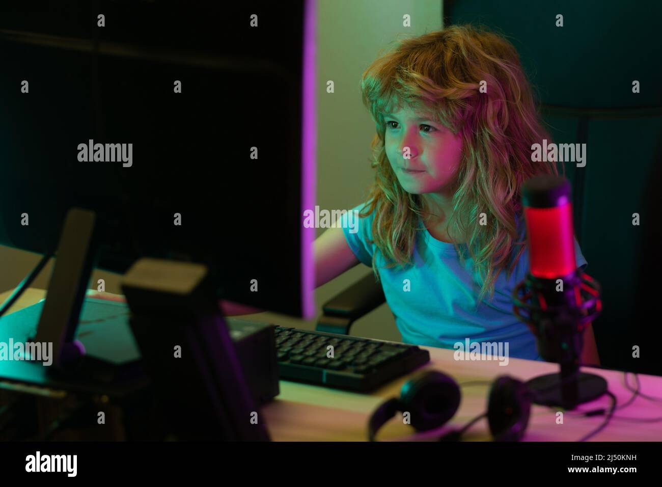 Child playing computer games or studying on pc computer. Kid gamer on ...
