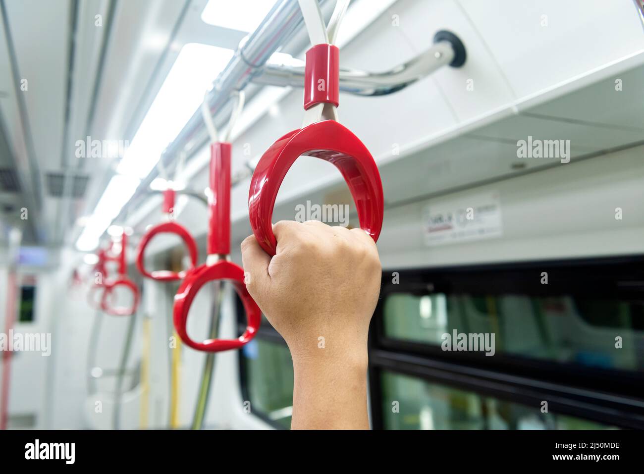 Passenger hand holding handle on the train for safety Stock Photo - Alamy