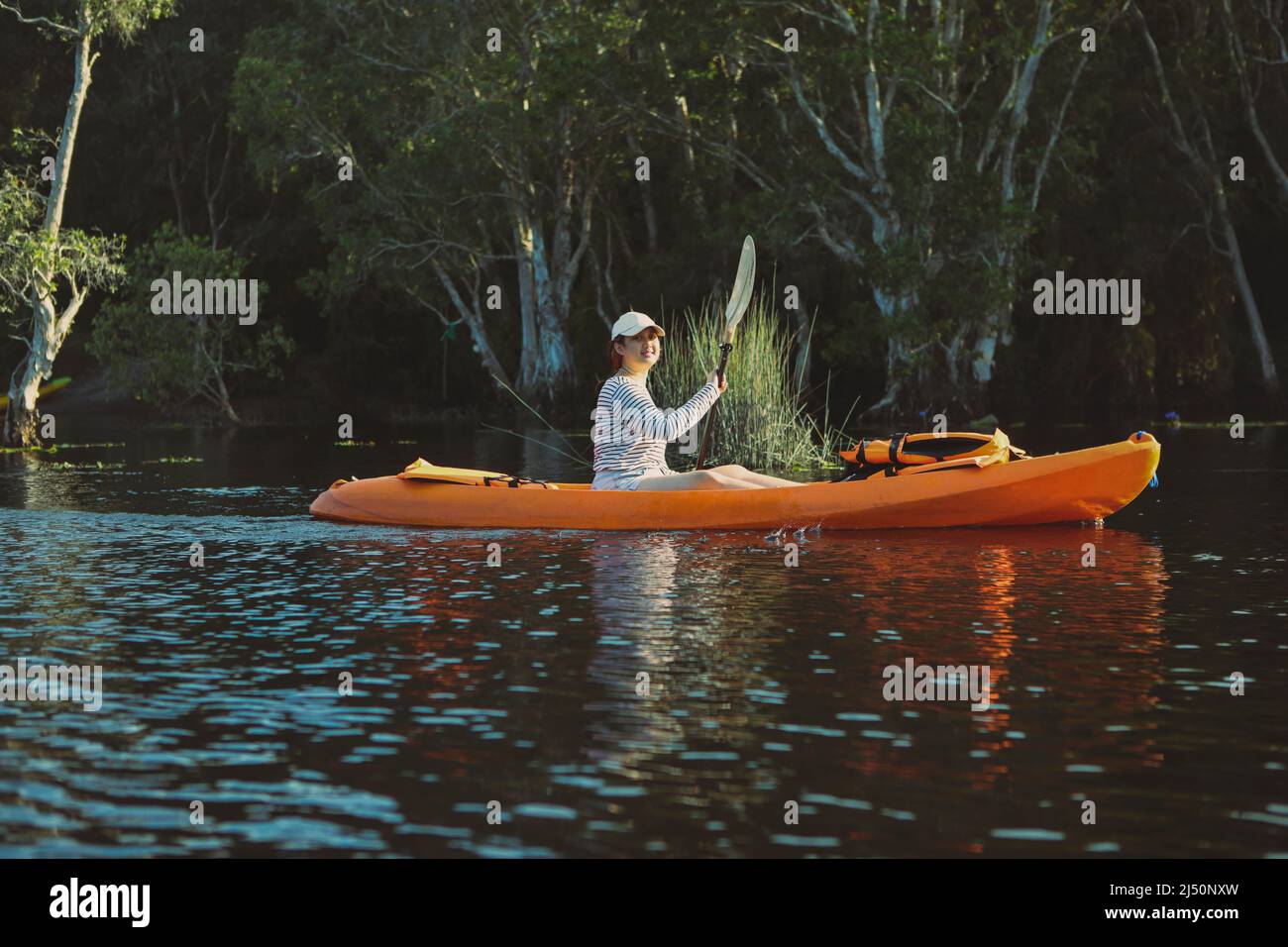 younger asian woman sailing sea kayak in fresh water lagoon Stock Photo ...