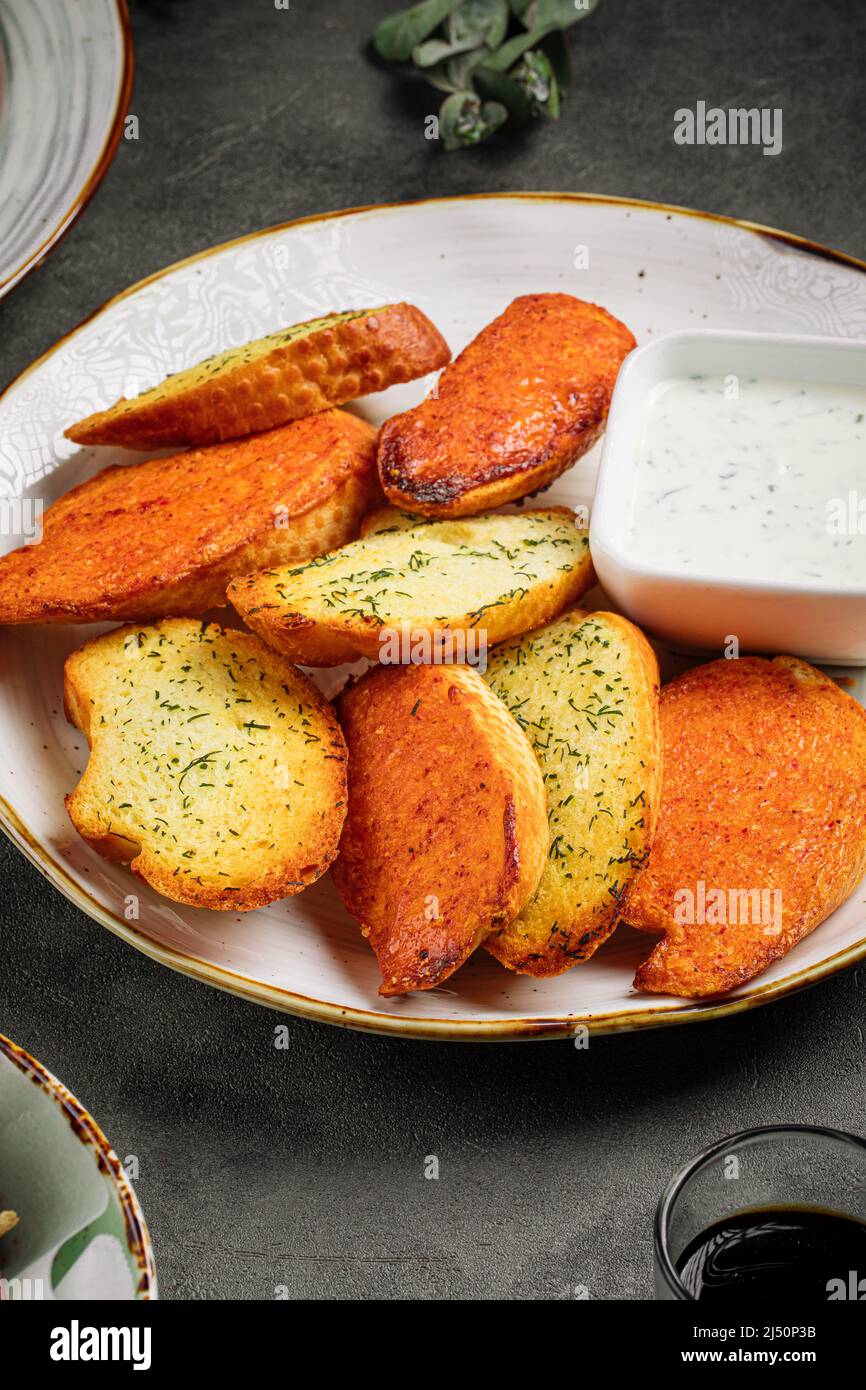 Garlic bread appetizer plate with sour cream sauce Stock Photo - Alamy