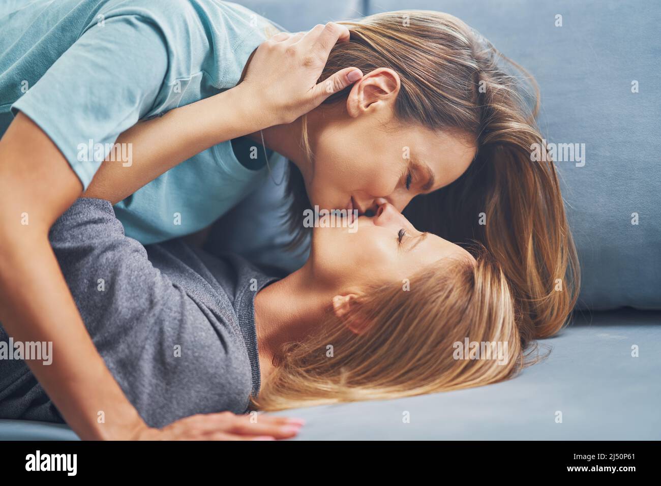 Two girl friends or lgbt couple in living room Stock Photo - Alamy