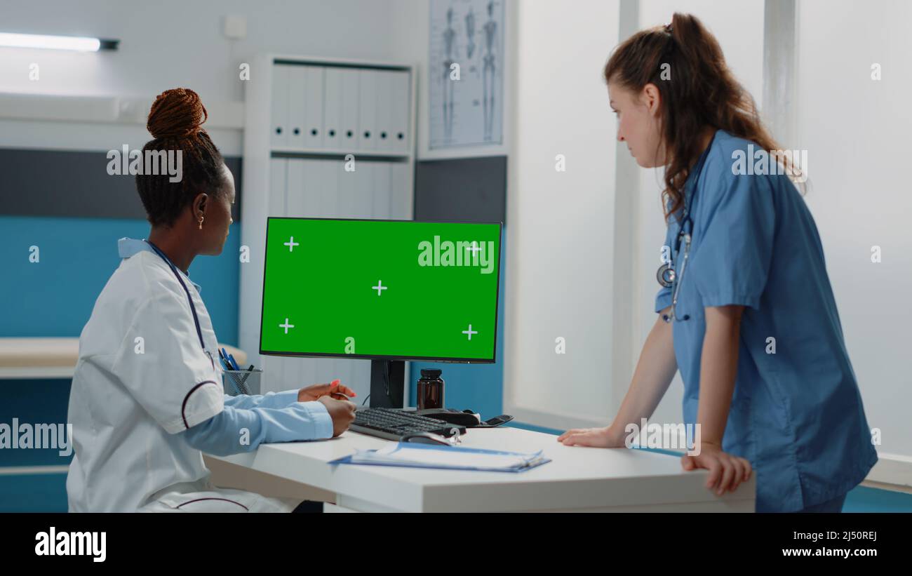 Group of doctor and nurse working with green screen on monitor in ...