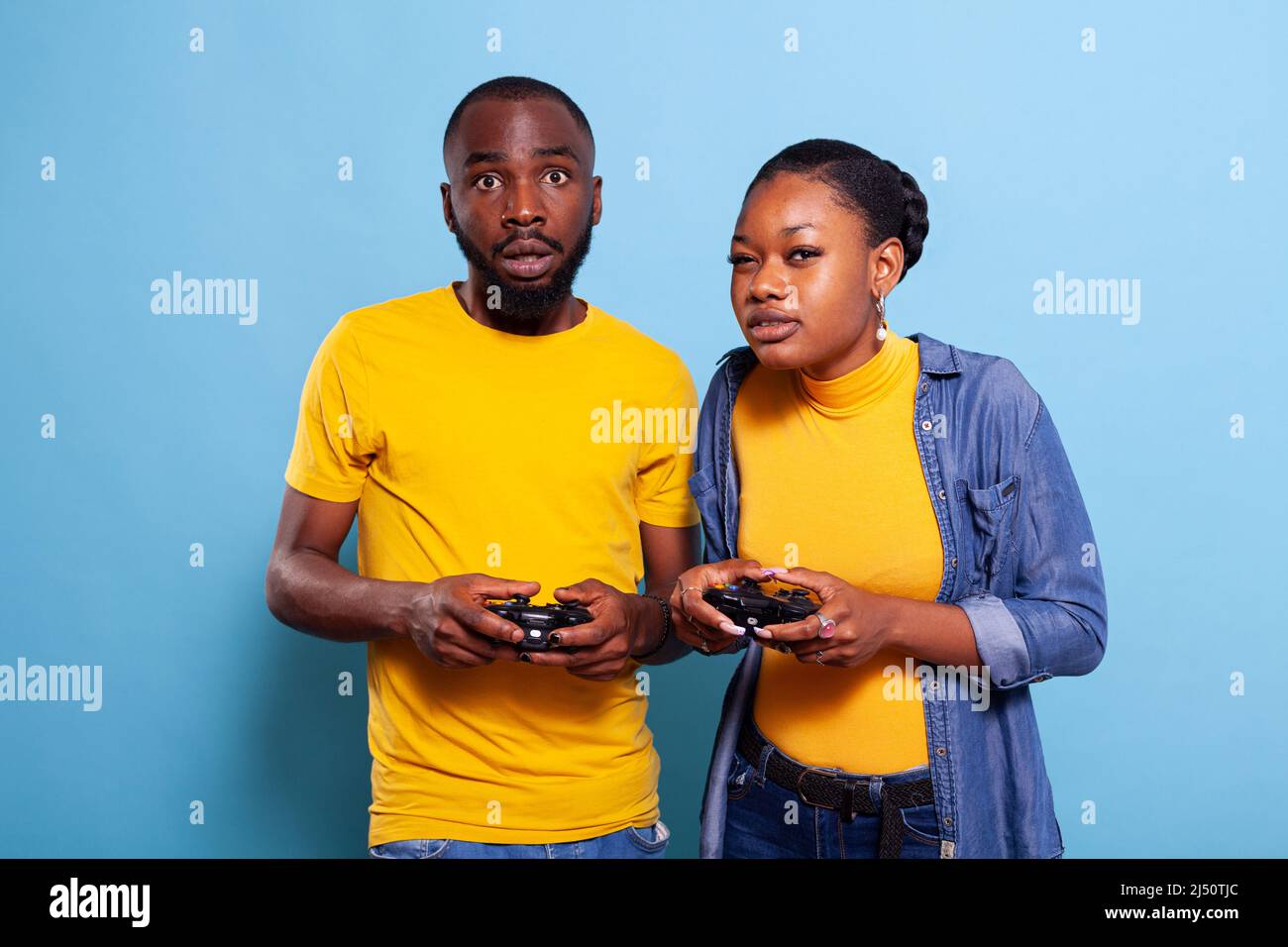 Boyfriend and girlfriend playing video games with controller on console ...