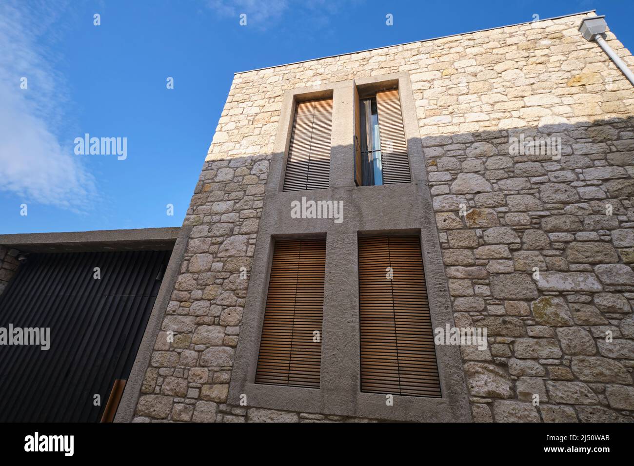 A view of a piece of modern, new house, stone architecture. In the town ...