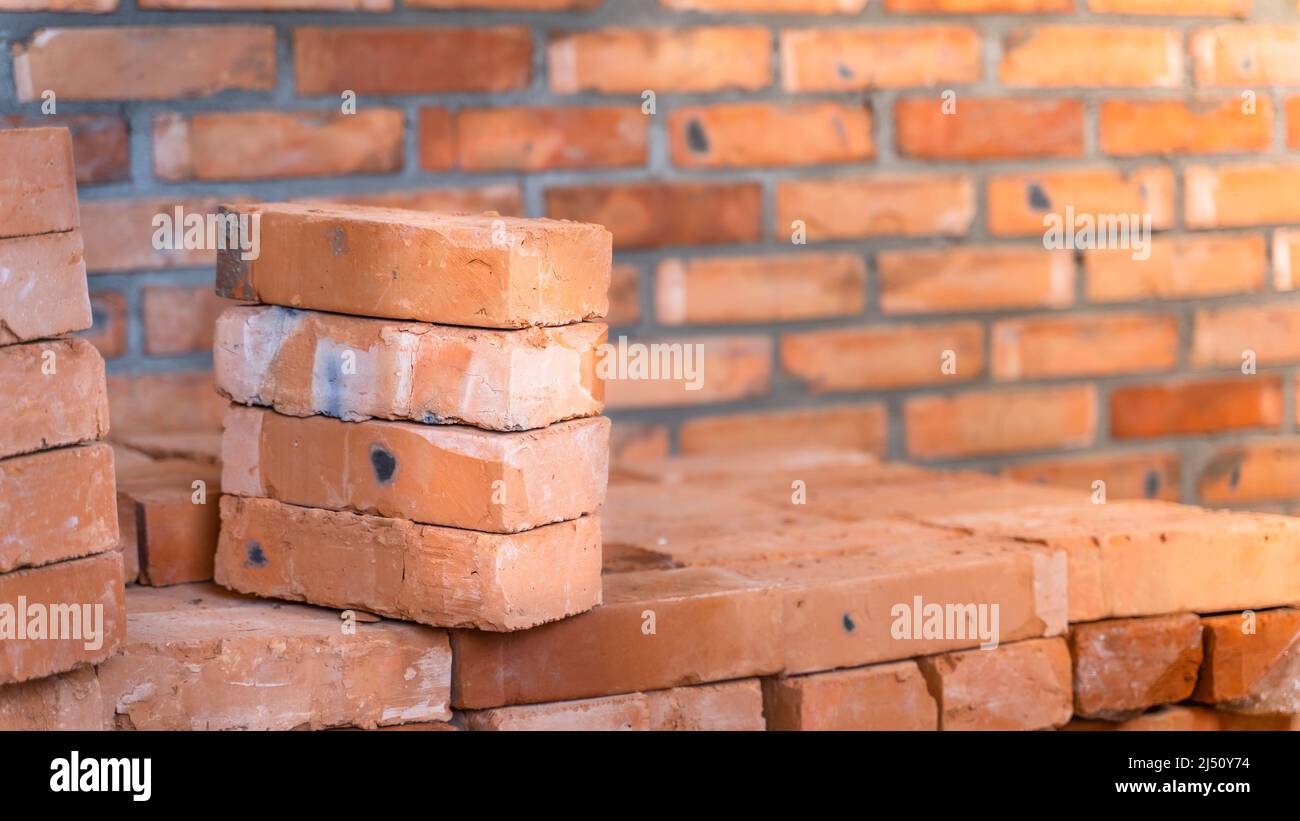 Red ceramic bricks stacked close up at a construction site. building ...