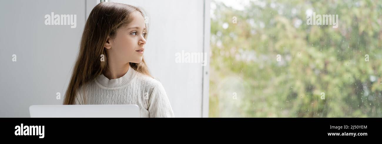 girl with laptop looking through window at home, banner Stock Photo - Alamy