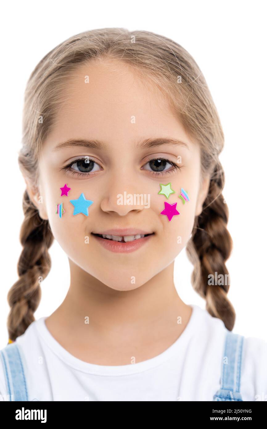 portrait of happy girl with braids and multicolored stars on face ...