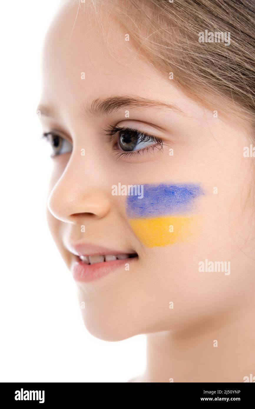 close up portrait of positive girl with ukrainian flag on face isolated ...