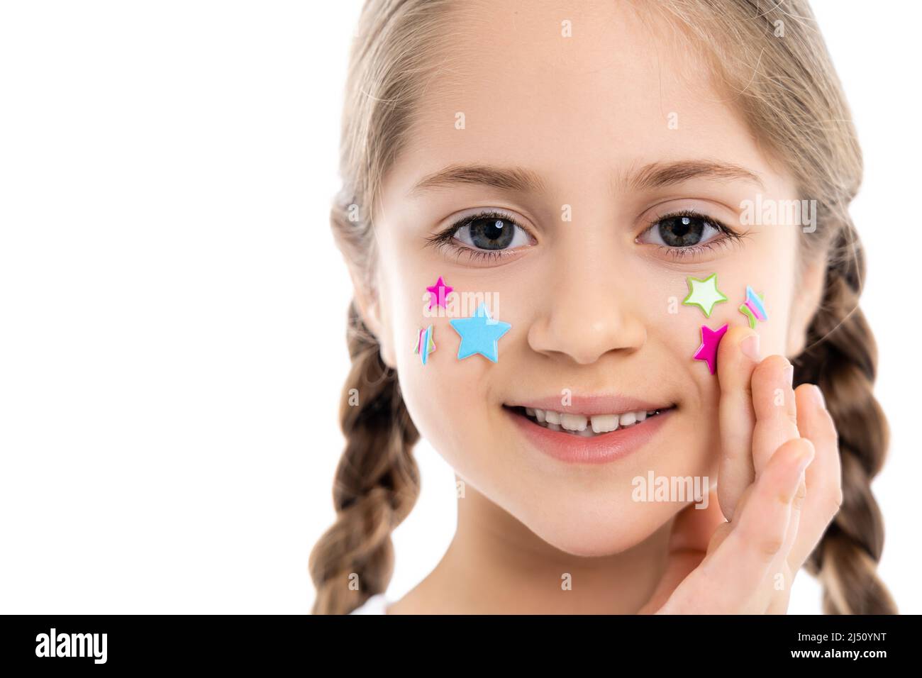 close up portrait of smiling girl touching colorful stars on face ...