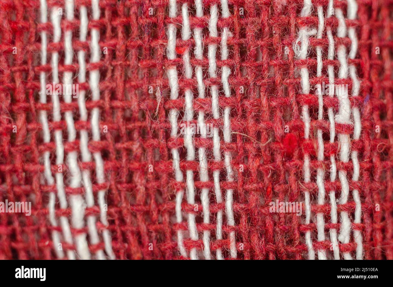 The texture of natural fabric. Perpendicularly woven white and red ...