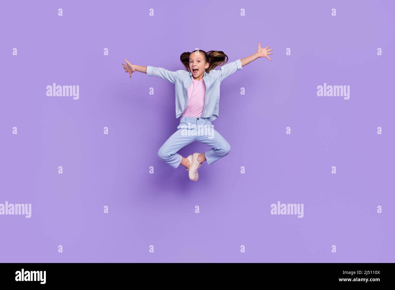 Photo of pretty funky little school girl wear denim shirt arms sides ...