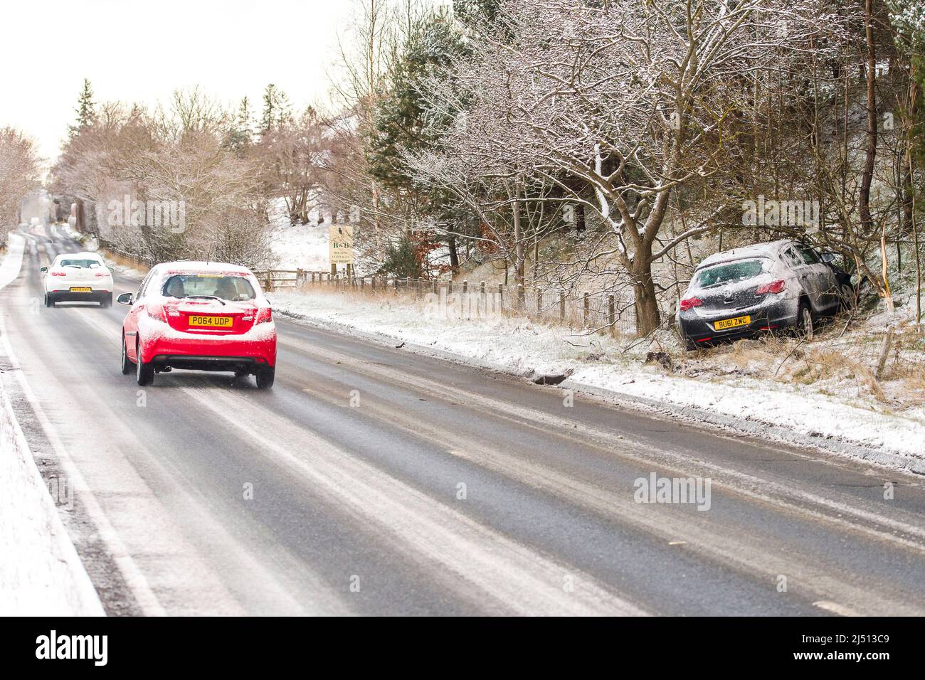 A car is seen crashed on the A703 near the Scottish Borders town ...
