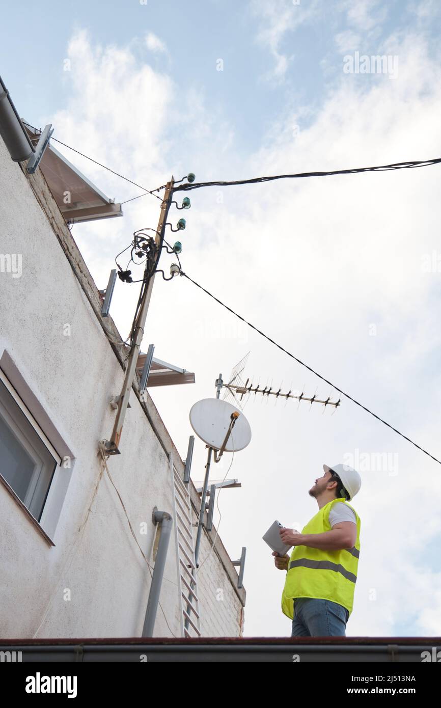 Technician checking electric wire power lines and telephone pole Stock ...