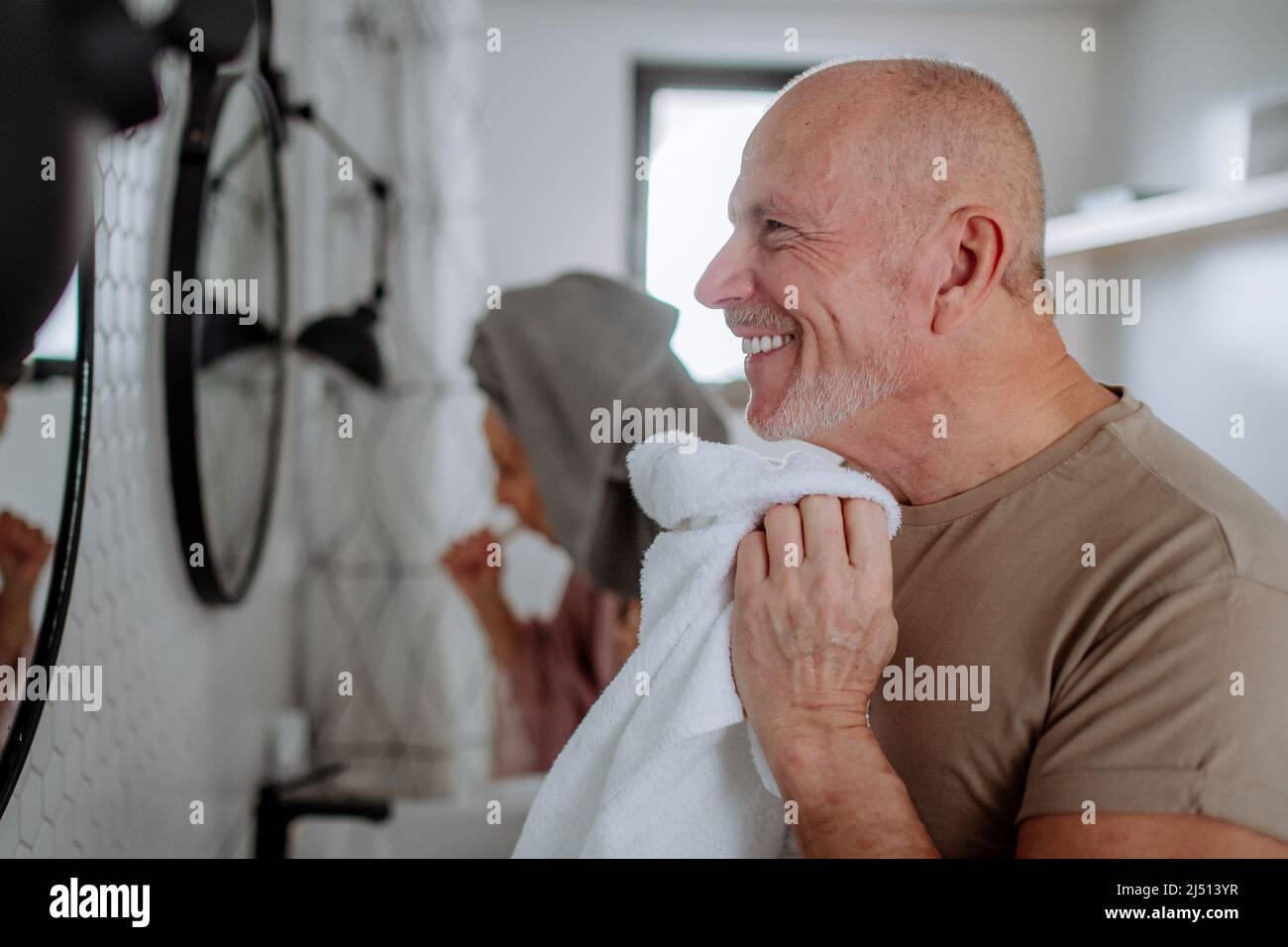 Senior couple in bathroom, washing face, morning routine concept Stock ...