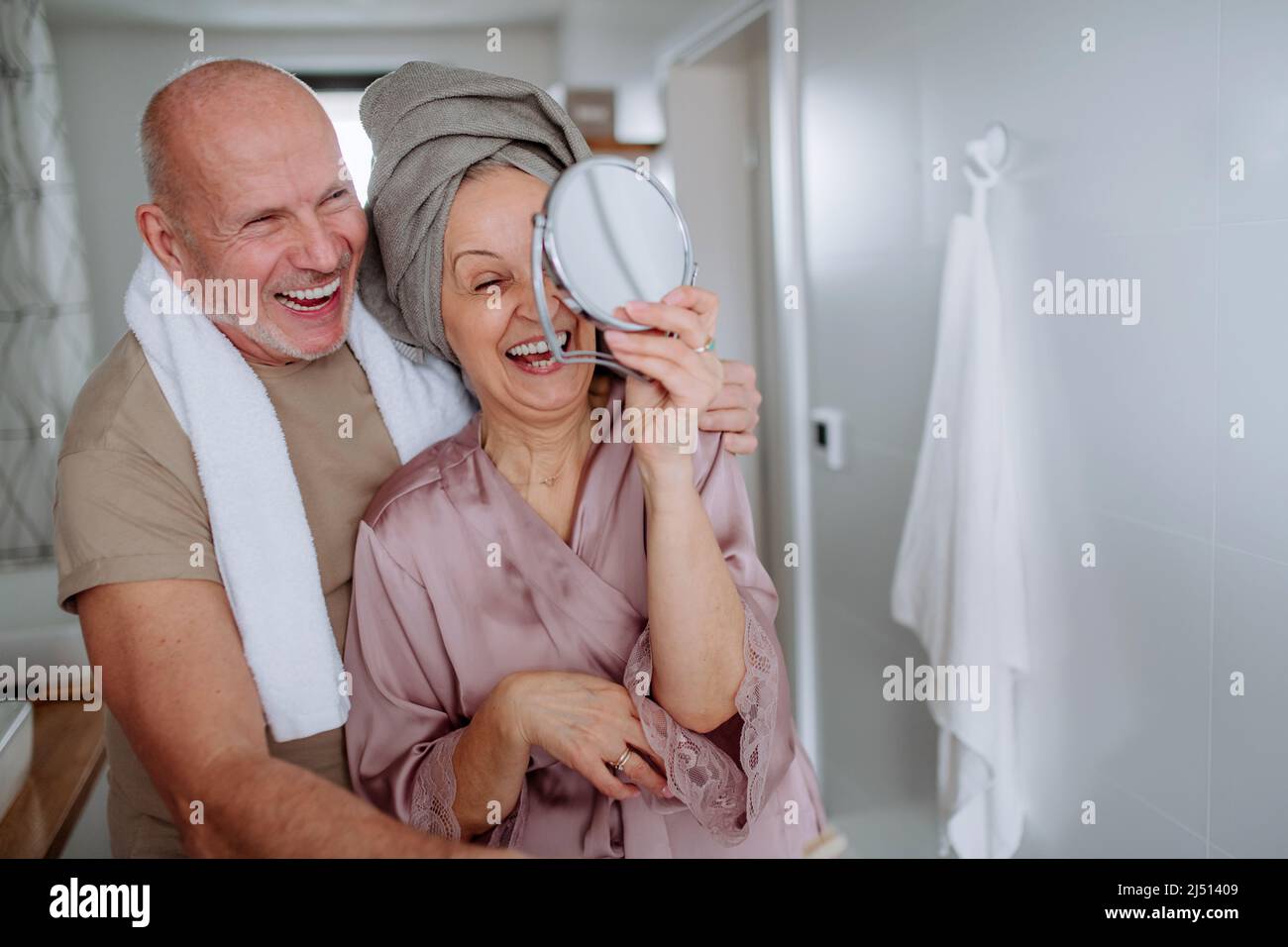 Senior woman brushing hair in mirror hi-res stock photography and ...