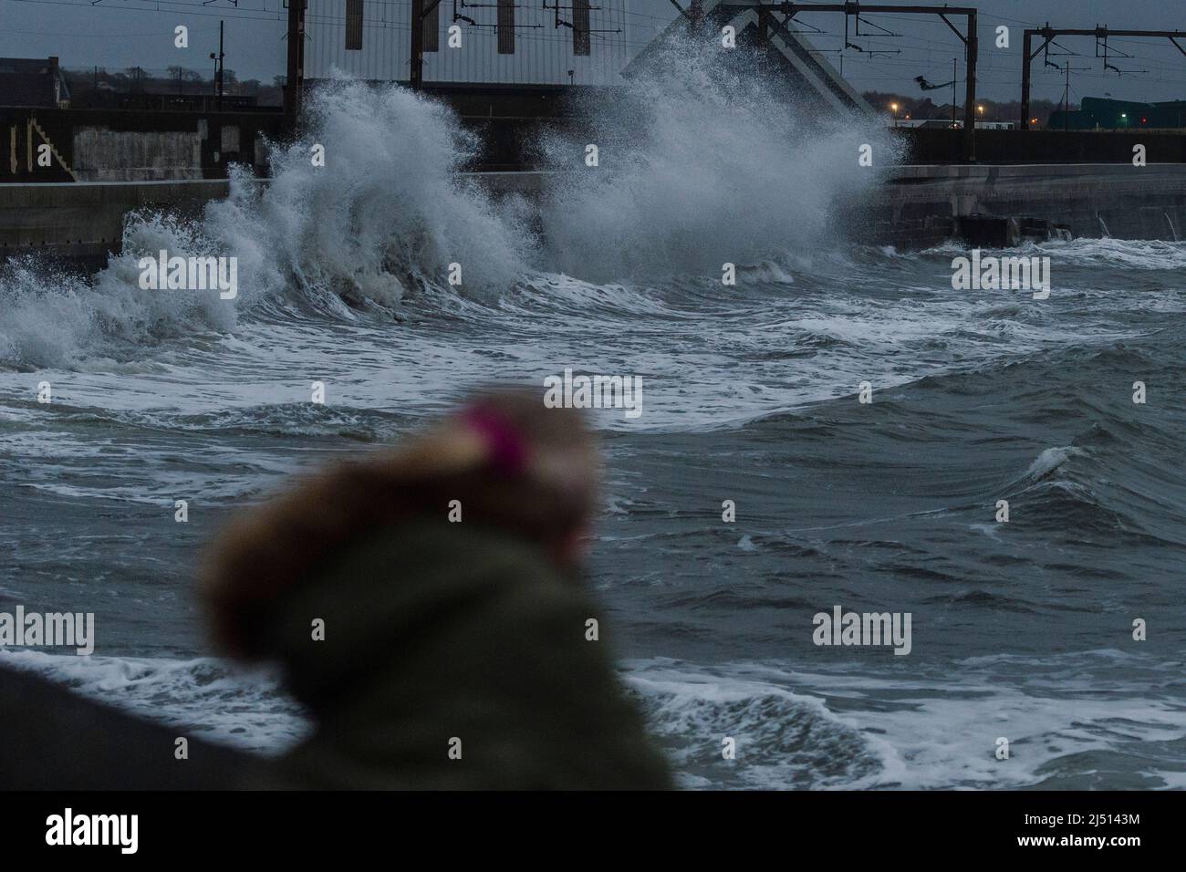 Waves are seen coming over the promenade at west coast Scottish town ...