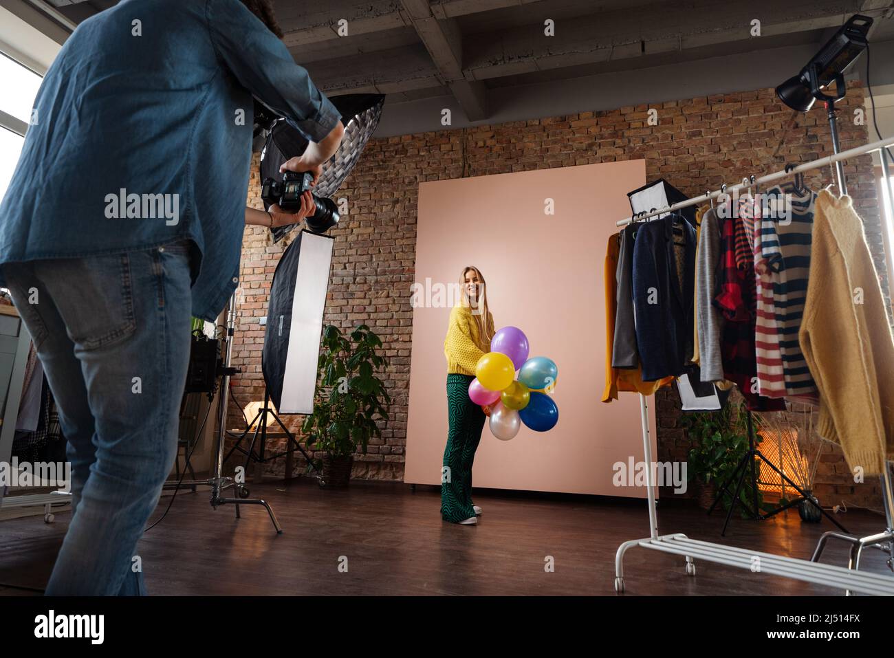 Fashion studio portrait of a happy young woman with balloons ...